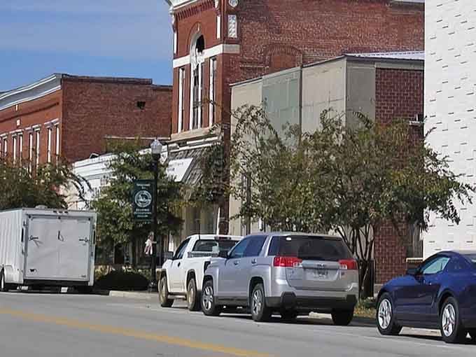 The mix of old brick and modern vehicles captures small-town life perfectly—honoring the past while living in the present.