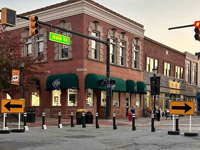Classic brick facades with green awnings create an inviting downtown where independent businesses still thrive against all odds.