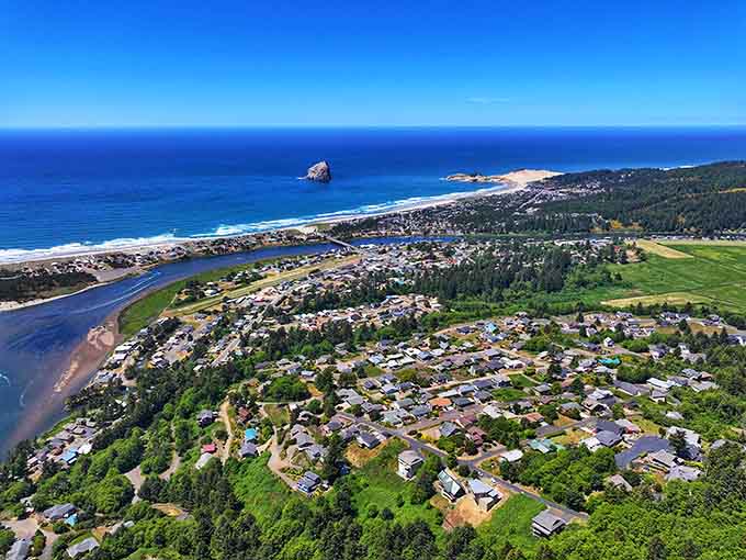 Pacific City spreads between forest and ocean, with Haystack Rock standing guard offshore like a giant sentinel of the sea.