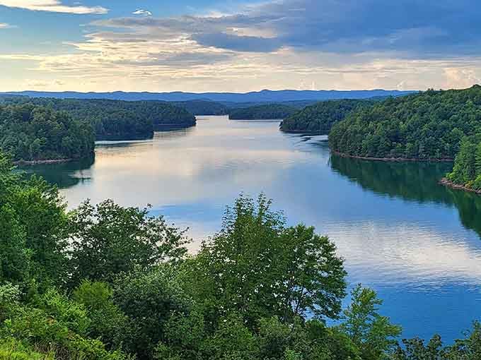 This elevated view reveals the lake's full majesty, with forested arms reaching into blue water like nature's own embrace.