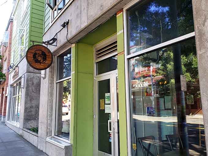 The cheerful green storefront hints at the feline paradise waiting inside, where whiskers and purrs are the main attraction.