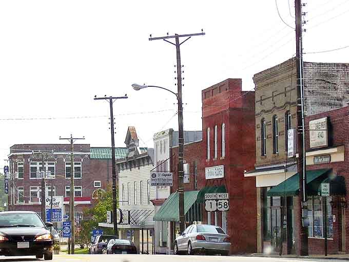 The weathered brick facades and vintage utility poles create an honest portrait of rural Virginia without any pretense.