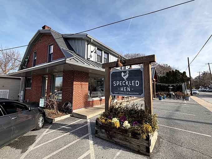 The rustic wooden sign surrounded by autumn flowers announces breakfast with more charm than Times Square has billboards.