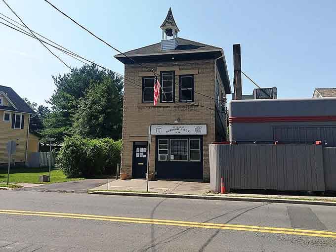 That charming cupola and flag make this tiny building look like it stepped out of a Norman Rockwell painting.