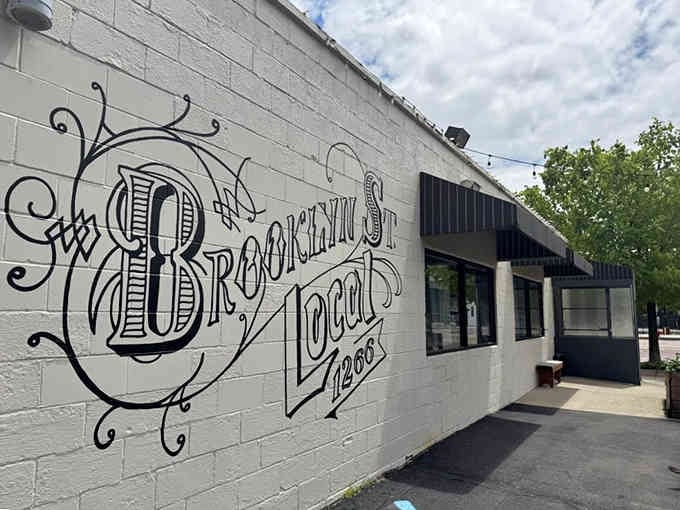 That gorgeous hand-painted vintage lettering transforms a simple wall into street art celebrating breakfast since way back when.
