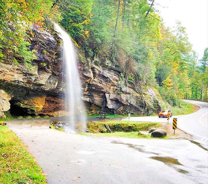 Nature's own roadside attraction: a waterfall cascading right onto the pavement, making every drive a photo opportunity worth stopping for.