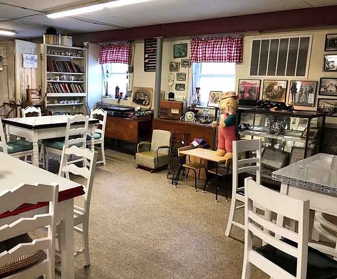 Red-checkered curtains and white furniture create a cozy country kitchen vibe in this nostalgic shopping space.