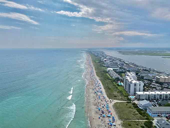 From above, the coastline reveals miles of sandy beach meeting water in every shade of blue imaginable.