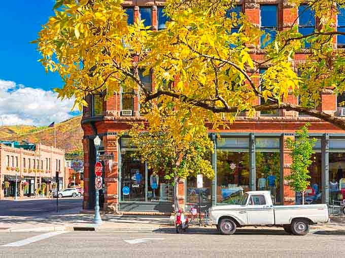 Fall aspens explode in gold behind historic brick facades, creating nature's perfect complement to human architecture and ingenuity.