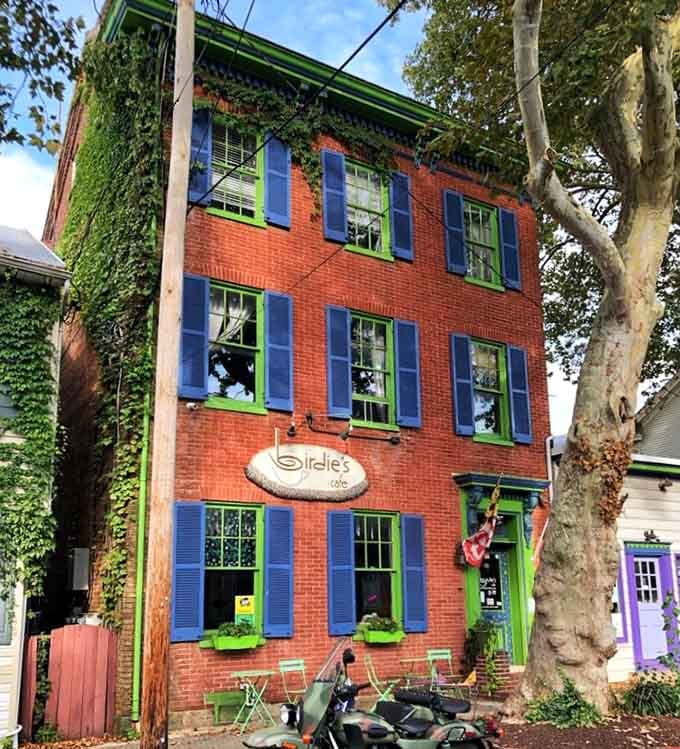 That three-story brick beauty with bold shutters looks like it stepped out of a postcard from yesteryear.
