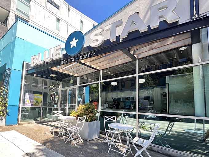 The star logo shines bright above inviting patio tables, creating an urban oasis for sophisticated donut enthusiasts everywhere.