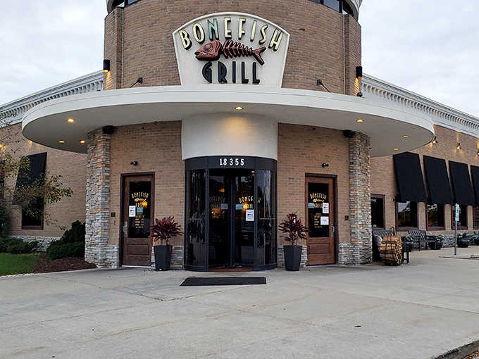 Evening lights illuminate an entrance that practically rolls out the red carpet for your dining pleasure.