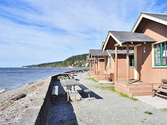 Charming beachside cabins line up like old friends, each offering front-row seats to spectacular Puget Sound sunsets.