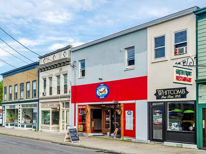 Bold red and white colors announce a welcoming spot nestled between neighboring shops on this bustling main street corner.