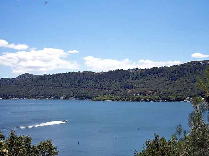 Speedboats carve white trails across sapphire waters backed by forested hills that seem to go on forever.