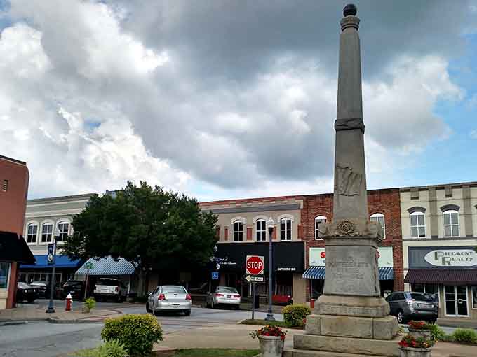 Historic monument framed by puffy clouds and brick buildings, creating Instagram-worthy views without the influencer prices.