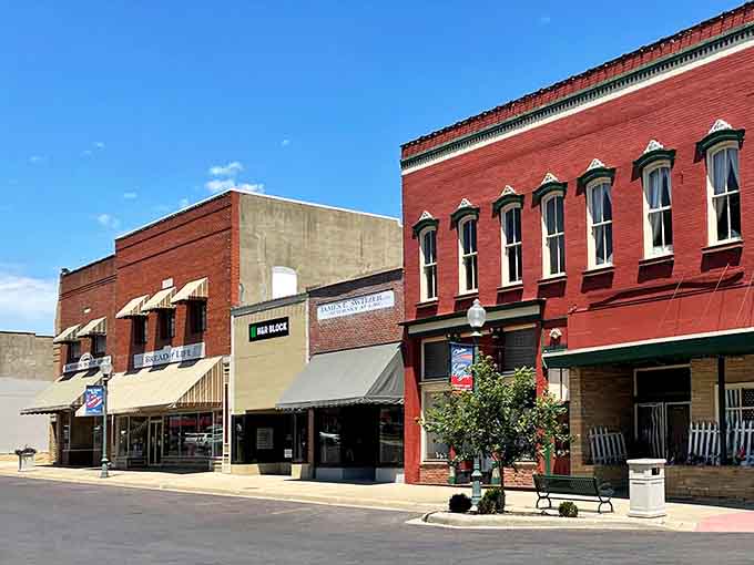 Brick buildings wear their age like badges of honor, standing shoulder-to-shoulder along streets that remember everything.