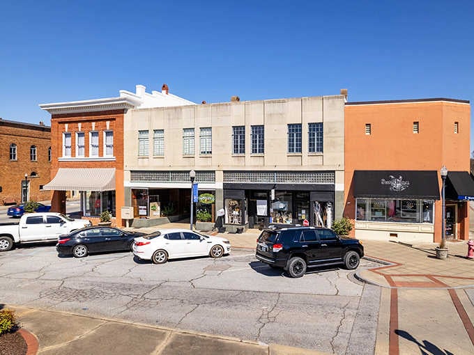 The downtown square bustles quietly with parked cars and brick facades that have witnessed generations of daily life.
