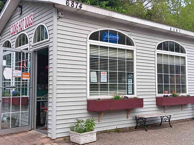The welcoming white exterior with its cheerful red accents looks like it belongs on a postcard celebrating classic Americana.