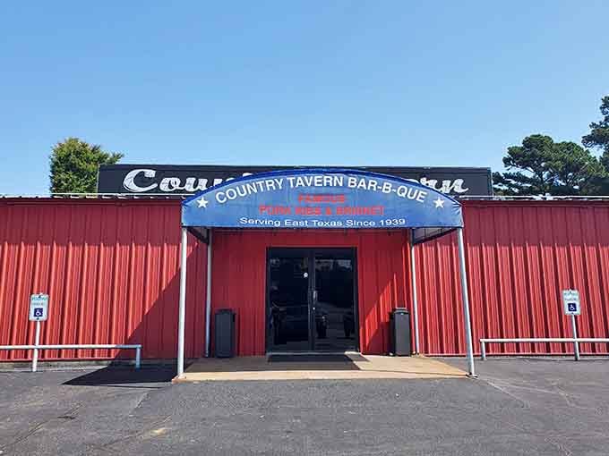 The patriotic awning and barn-red walls promise honest barbecue without pretense, just like grandma would approve.