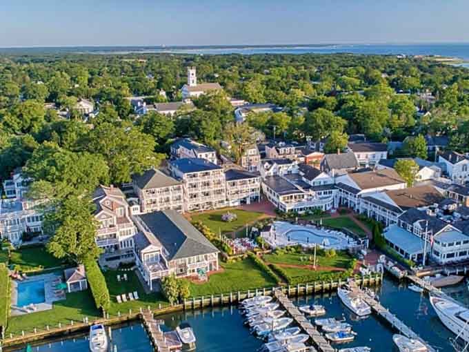 From above, the harbor town reveals its secret: elegant homes nestled among trees with boats waiting at private docks.