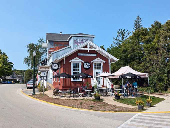 The red barn-style building welcomes visitors with outdoor seating perfect for people-watching and relaxing completely.