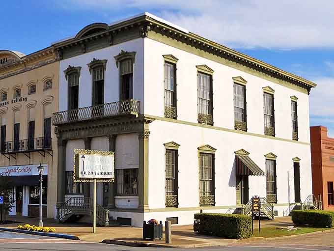 Elegant ironwork balconies adorn this pristine white building that stands as a jewel of historic downtown preservation efforts.