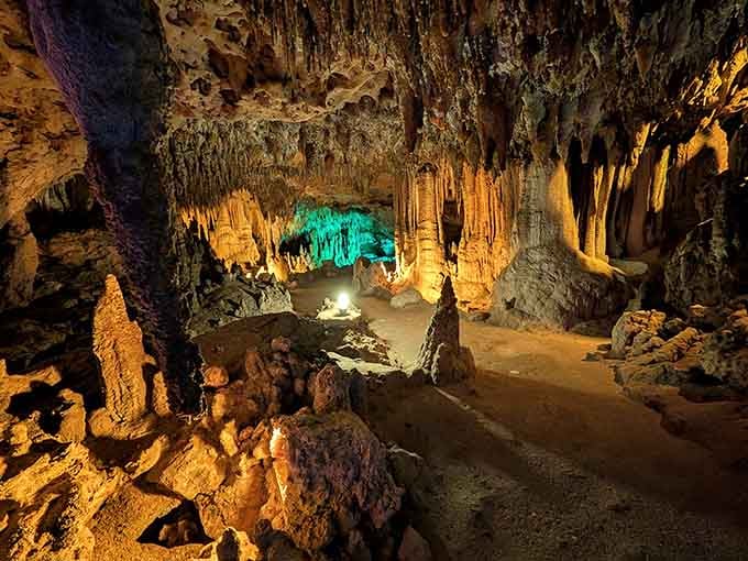 Dramatic lighting transforms limestone formations into an otherworldly landscape that rivals any theme park's special effects.
