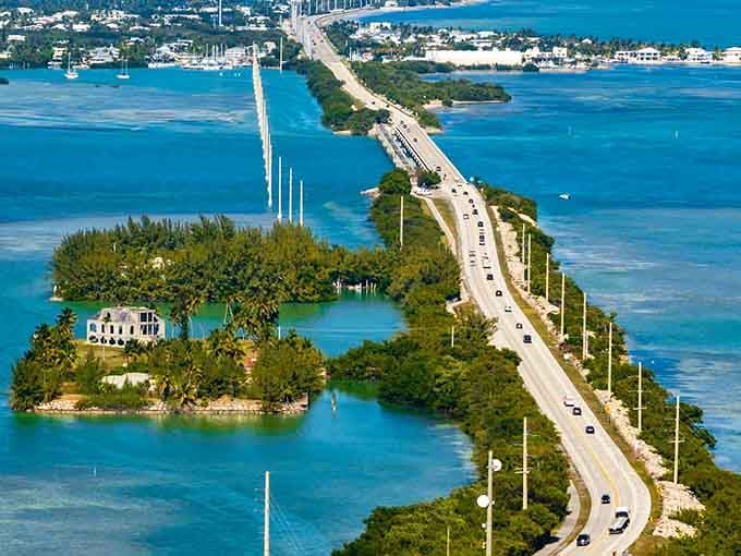 Island greenery dots the aqua waters as the Overseas Highway curves gracefully through this tropical paradise landscape.