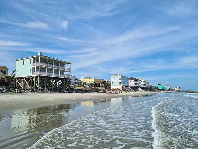 Colorful beach houses on stilts stand like sentinels along the shore, weathering whatever nature throws their way.