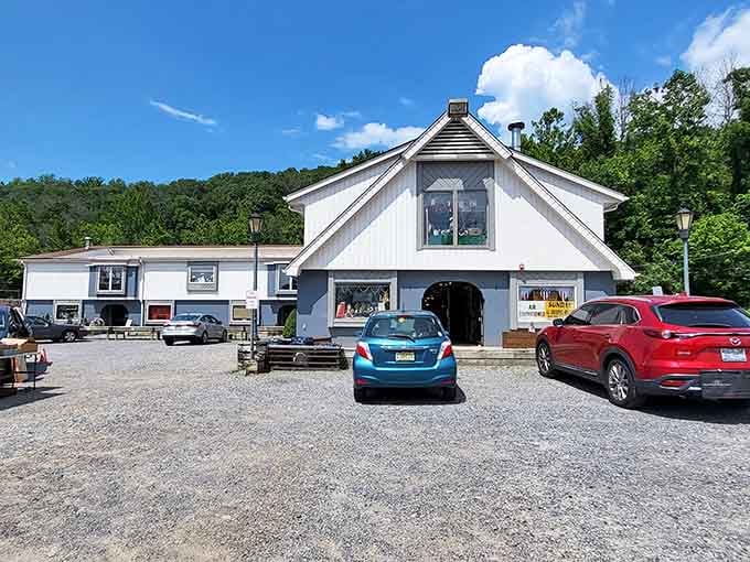 The charming white barn-style building welcomes visitors with old-fashioned hospitality and promises of vintage treasures within.
