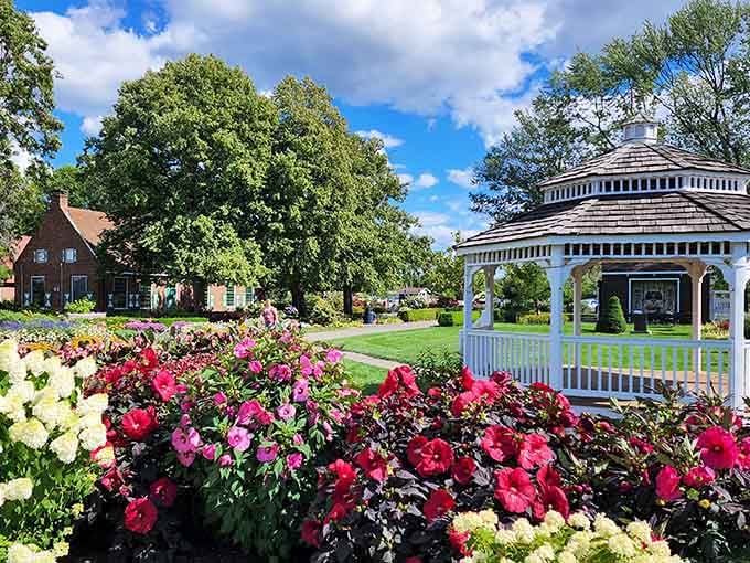 This gazebo surrounded by vibrant blooms creates a garden scene worthy of stopping to smell every single flower.