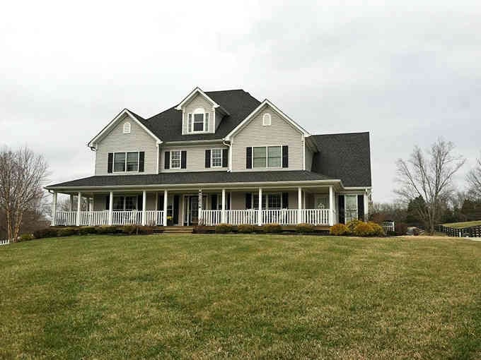 That wraparound porch on this hilltop beauty practically begs you to sit with sweet tea and watch the sunset.