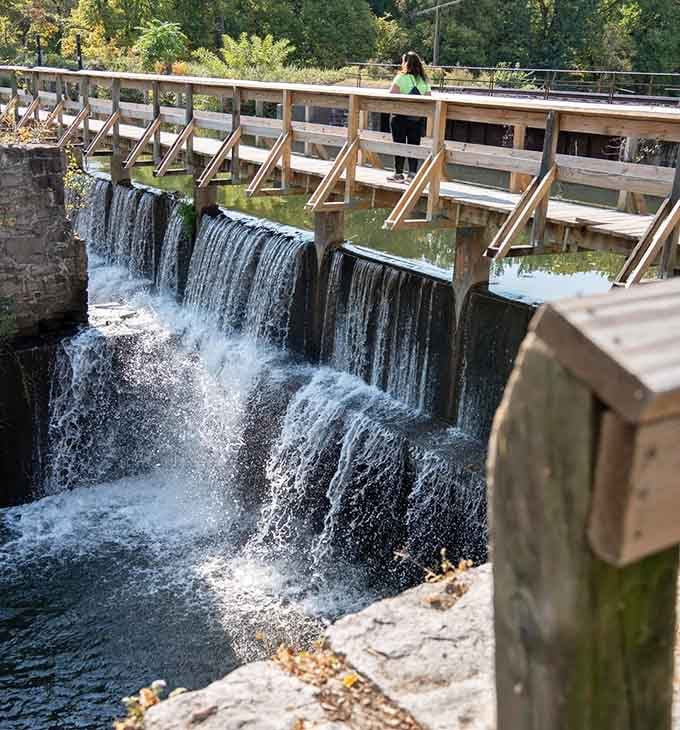 The wooden footbridge offers front-row seats to nature's daily performance, complete with rushing water and cool spray.