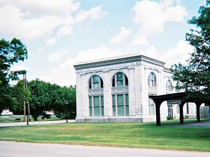 Classical architecture meets open green space at this striking white building, standing proud like a monument to civic pride and community values.