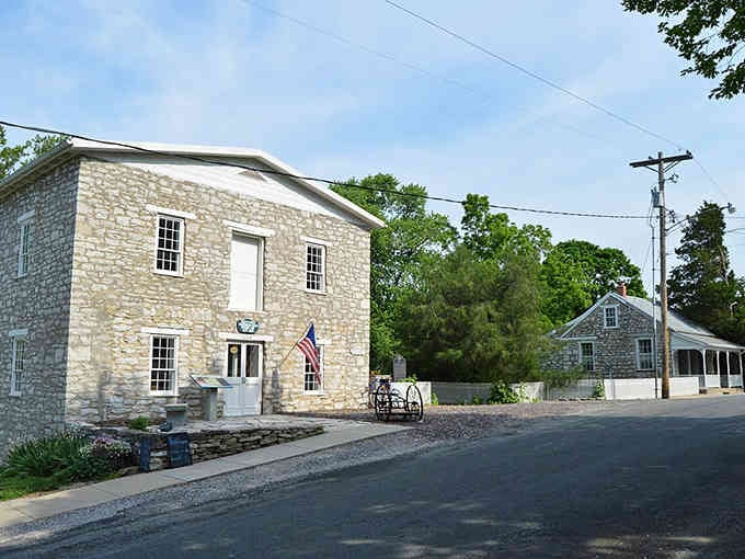 This corner building's white trim against weathered stone creates the kind of authentic charm that Hollywood set designers try desperately to recreate.