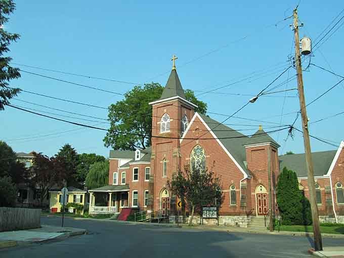 The brick church tower rises above the trees, calling the faithful home since your great-grandparents' courting days.