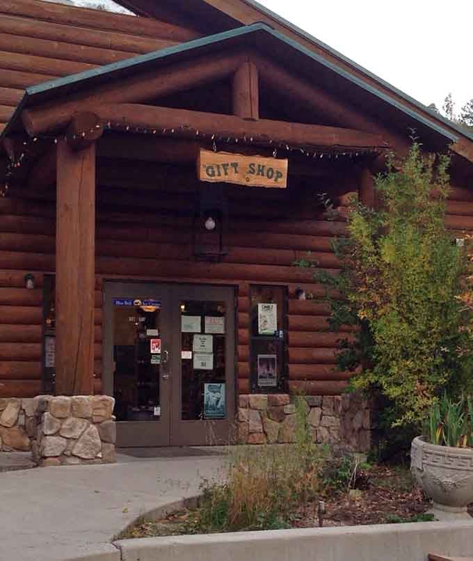 The gift shop entrance beckons with rustic charm, promising treasures inside this cozy mountain retreat where altitude meets attitude adjustment.