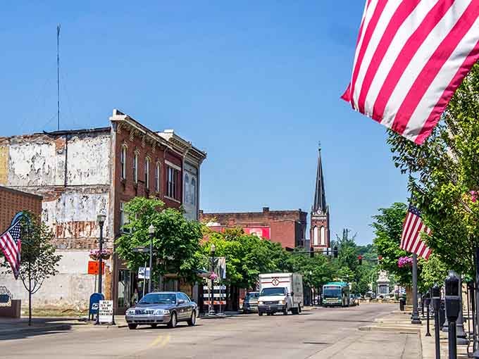 American flags wave proudly above storefronts where local businesses have served neighbors for generations without pretense.