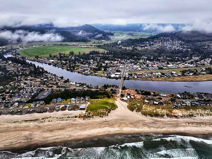 Dramatic clouds hover over the river valley, where beach and farmland create a patchwork landscape that defies typical coastal expectations.