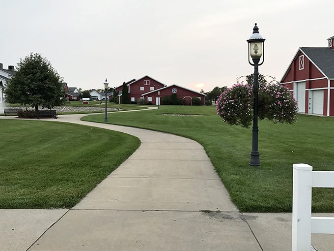 Winding sidewalks and classic lampposts lead past red barns, blending rural charm with suburban comfort.