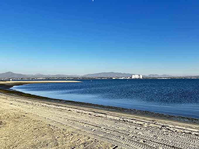 Calm bay waters reflect the sky like a mirror, creating the kind of serenity that resets your soul.