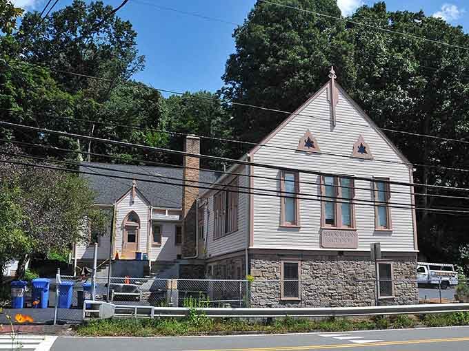 Stone foundation meets classic architecture where community gatherings have happened for generations under those towering trees.
