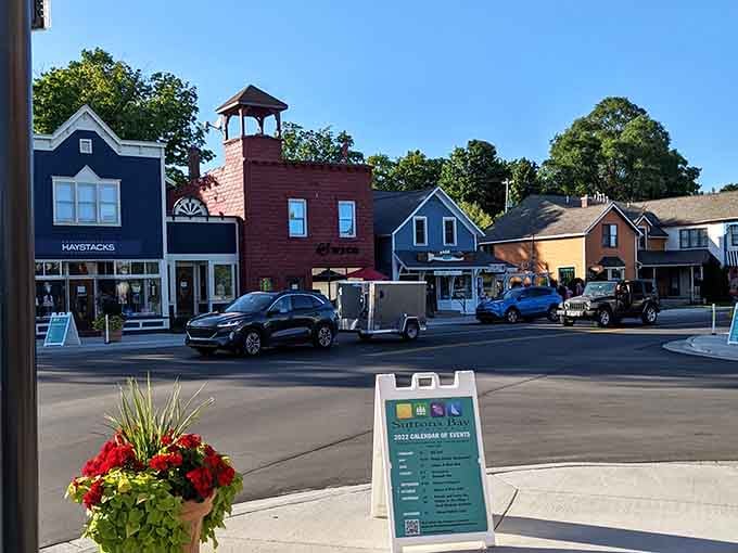 The bell tower and painted buildings create a storybook scene that makes you want to park and explore every shop.