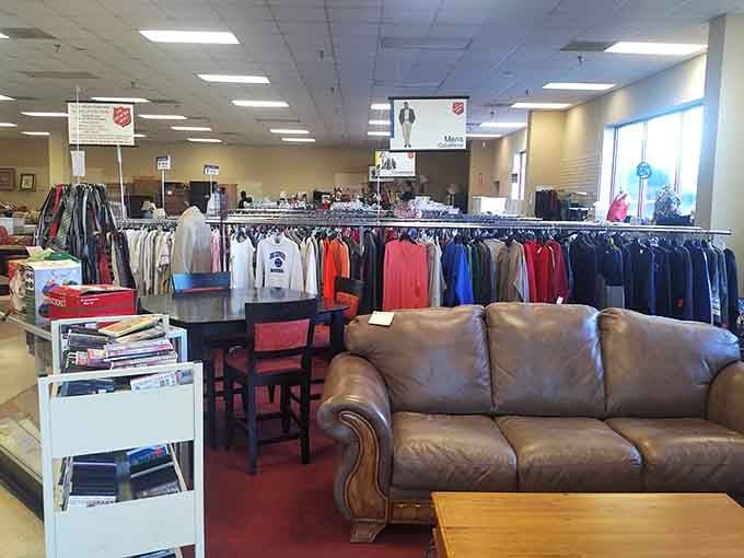 Leather couches and organized racks create a surprisingly upscale atmosphere where thrift shopping feels downright sophisticated here.