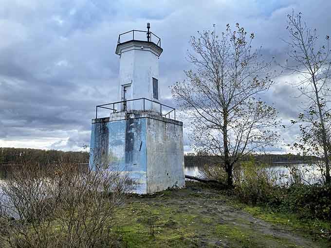 The compact beacon overlooks the Columbia's wide waters, its white paint peeling with character that tells stories of countless river journeys.