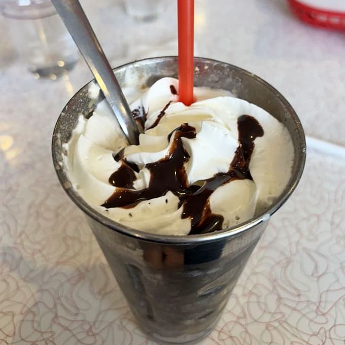 Hand-dipped chocolate malts thick enough to require genuine effort, served in classic metal cups like grandma remembers.