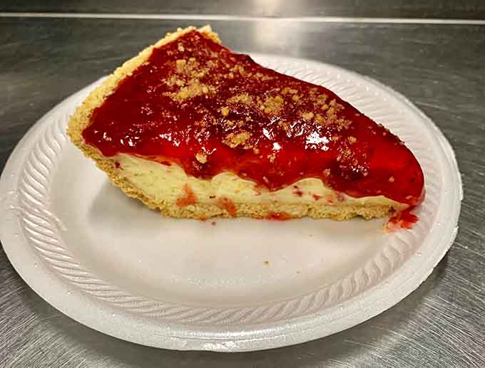 Ruby-red cherry filling glistening under the lights makes this classic pie slice look like something from your grandmother's best recipe.