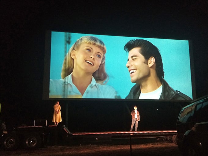 Watching "Grease" at a drive-in is so meta it almost breaks the space-time continuum, and we're absolutely here for it.