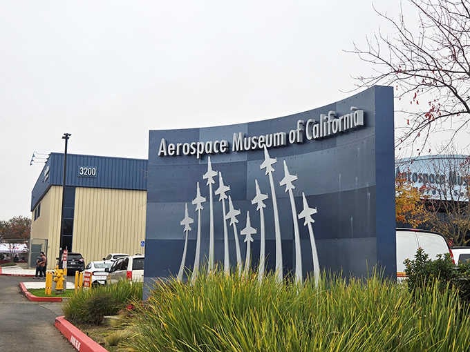 The museum's entrance promises aviation adventures inside, with silhouettes of jets climbing skyward in perfect formation overhead.